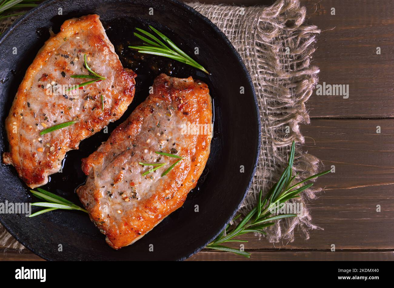 Roasted pork steaks on wooden background, top view. Top view, flat lay ...