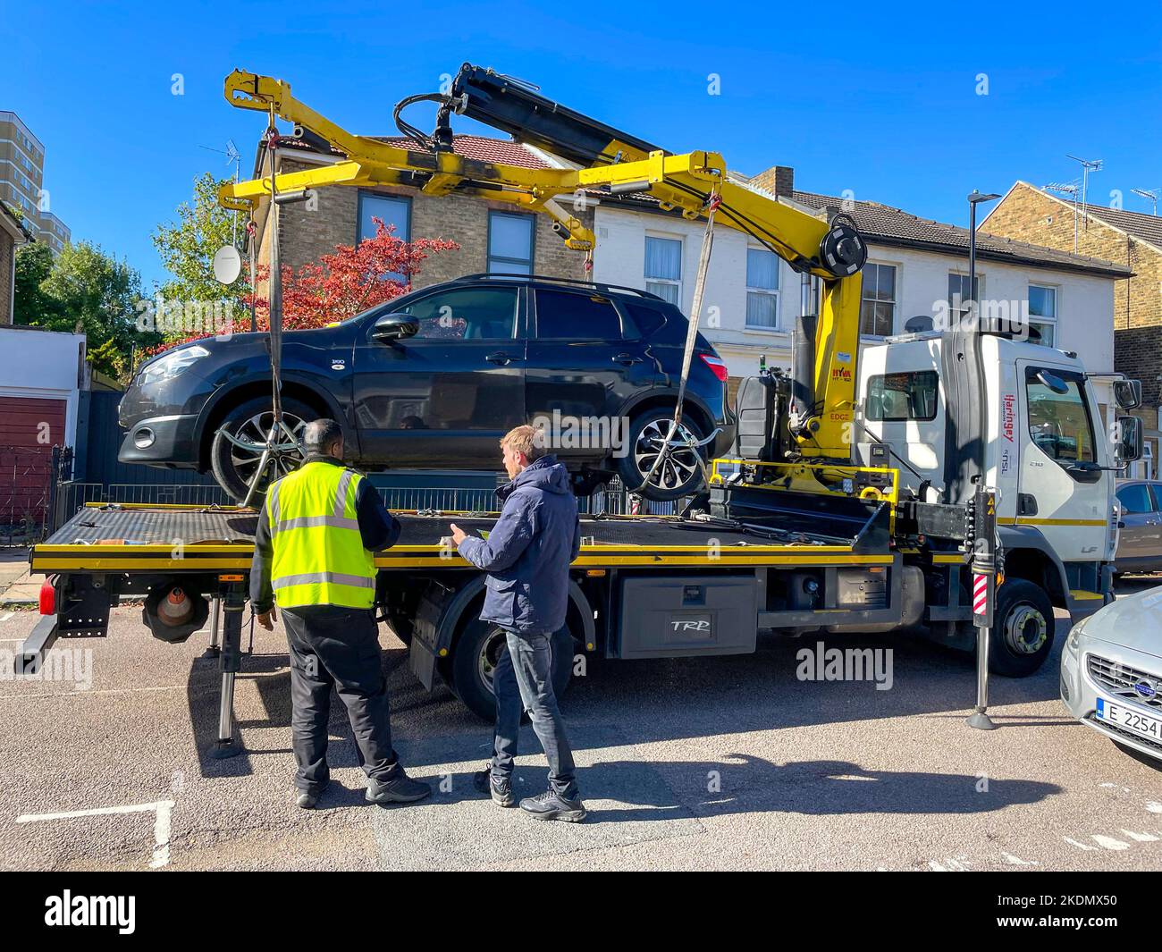 Police lift a car for removal after a parking offence. The owner ...