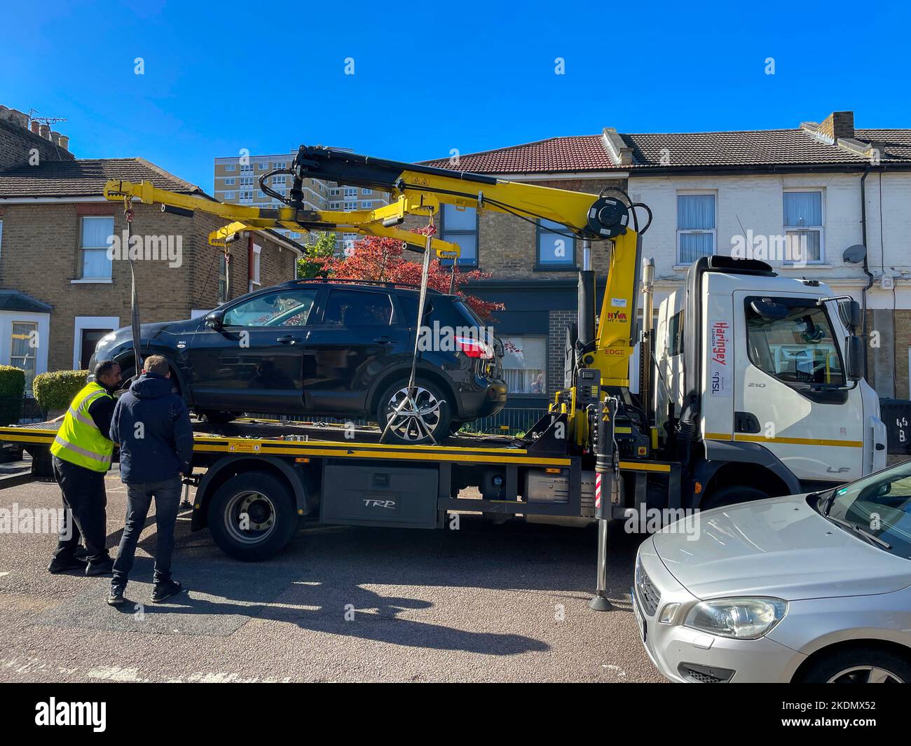 Police lift a car for removal after a parking offence. The owner ...