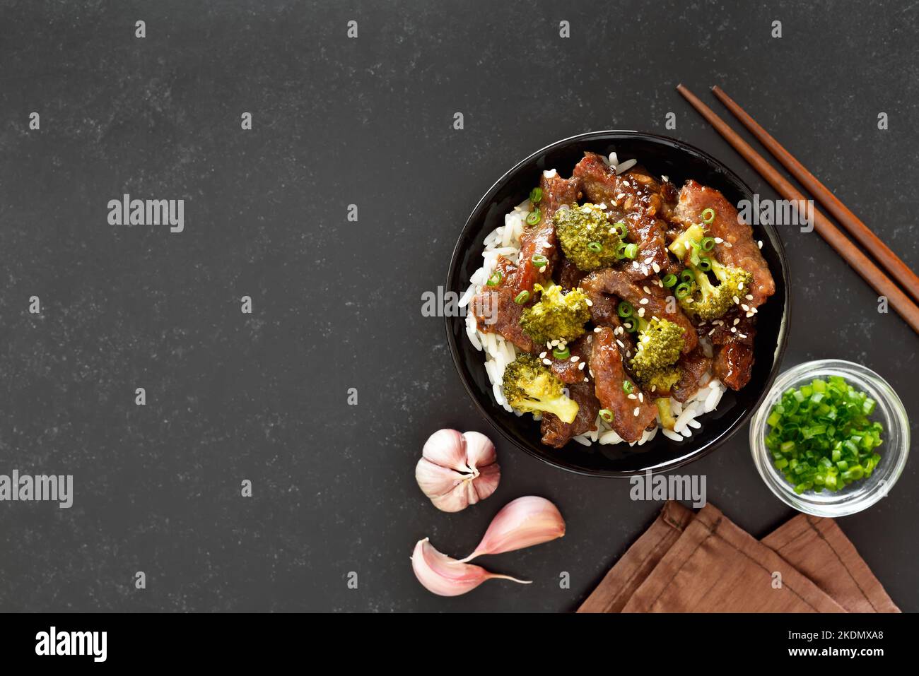 Beef stir-fry with broccoli on black stone background with copy space ...