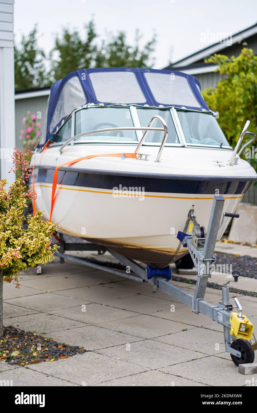 Small motorboat on trailer parked in driveway near house Stock Photo ...