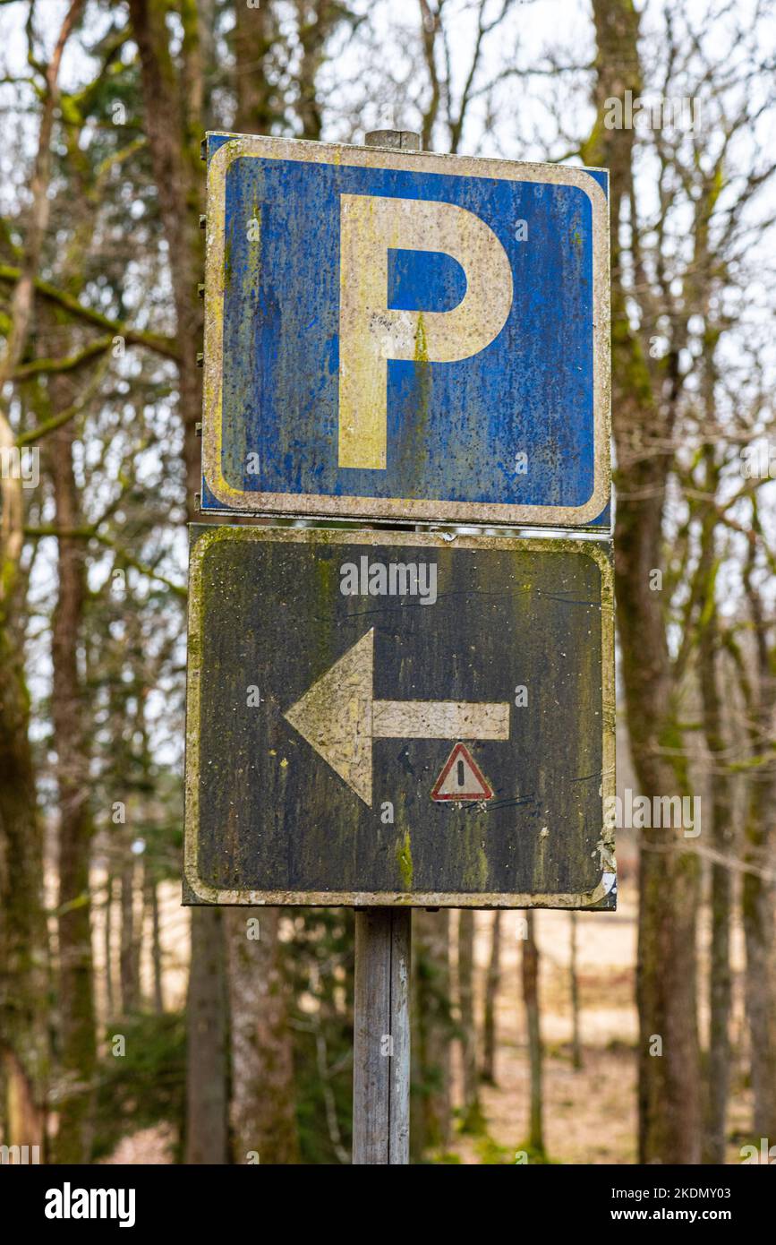 Old and mossy parking sign Stock Photo - Alamy