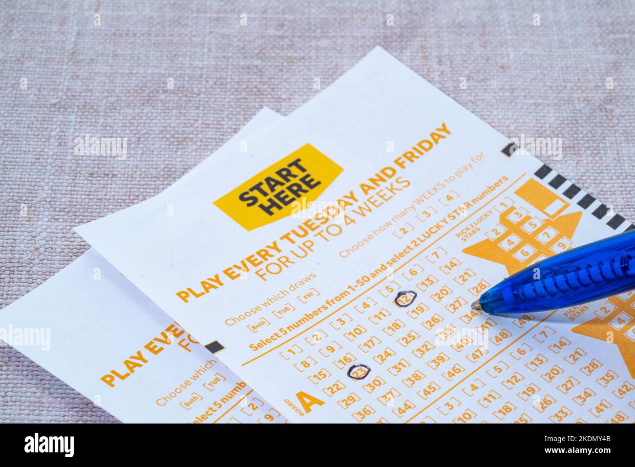 Pen marking numbers on a lottery ticket Stock Photo - Alamy