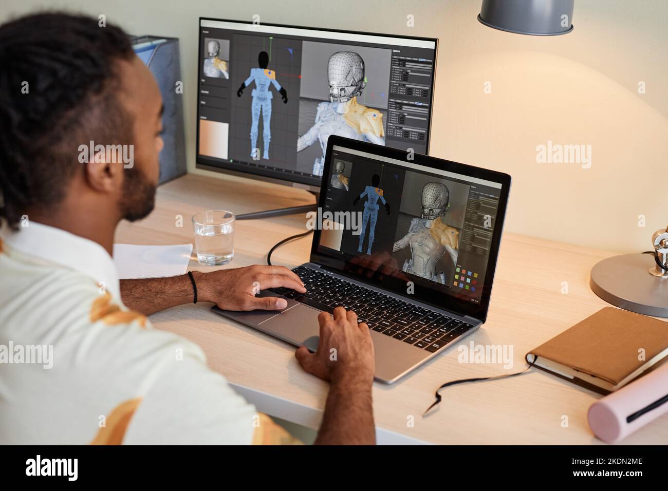 Back view at creative black man building digital 3D models and using ...