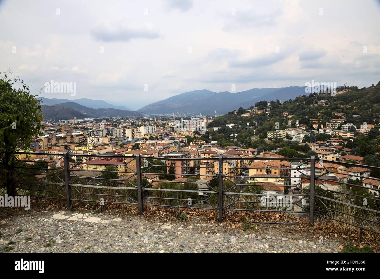 Panoramic point with a city below next to a mountain range on a cloudy ...