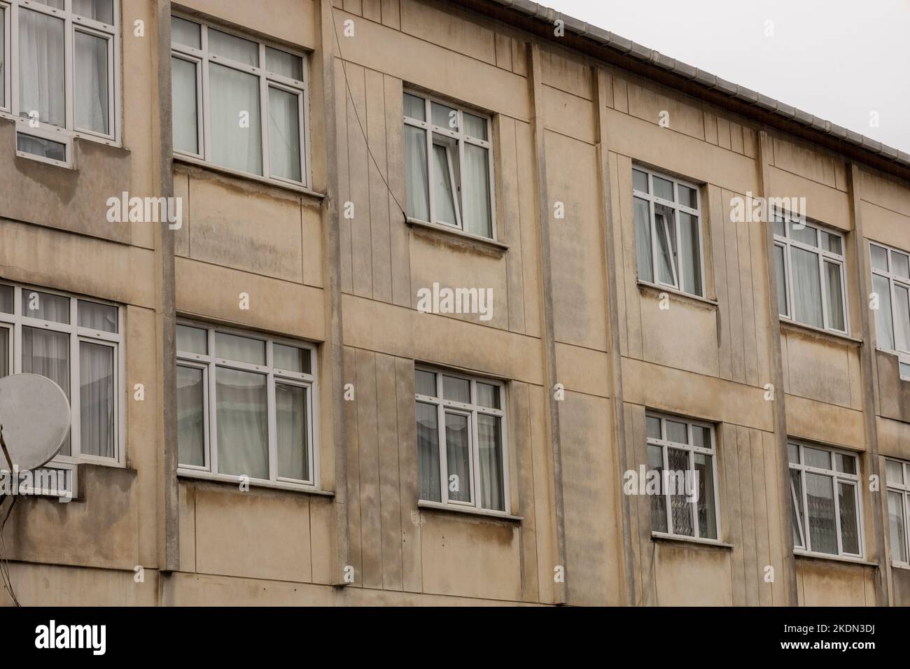 Closeup white house with endless similar windows. White building looks ...