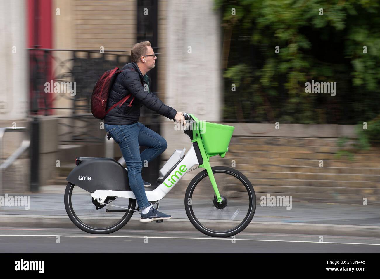 A man riding a Lime electric hire bike along Waterloo Road, London, UK ...