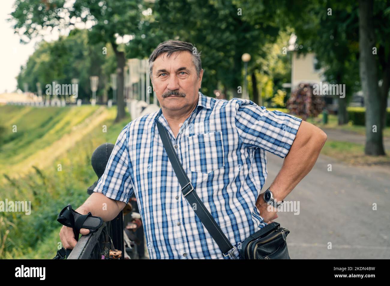 Portrait of a very old man 70 years old with a bag. Grandpa is resting ...