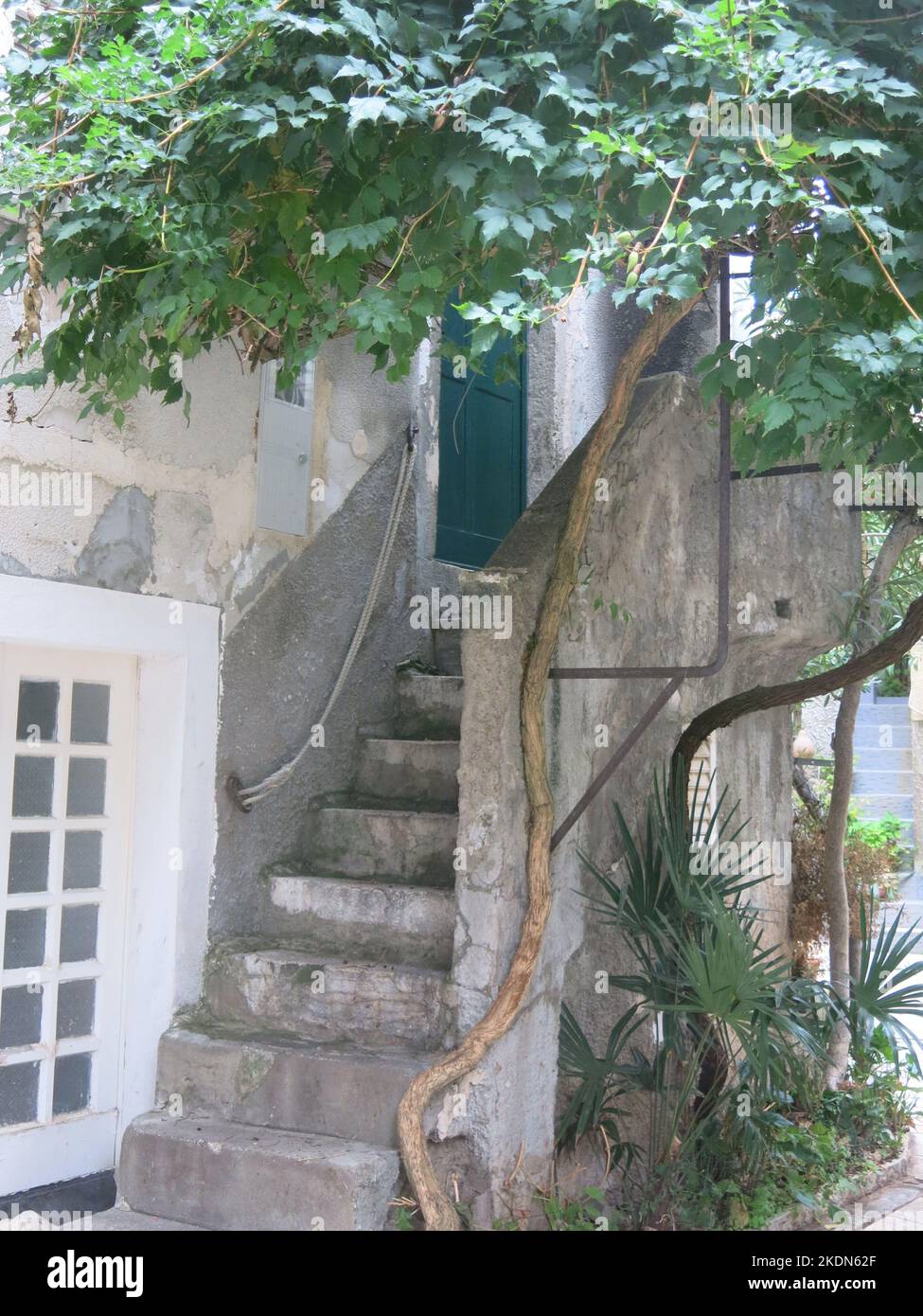 In the medieval streets of the old town of Cres, stone staircases lead ...