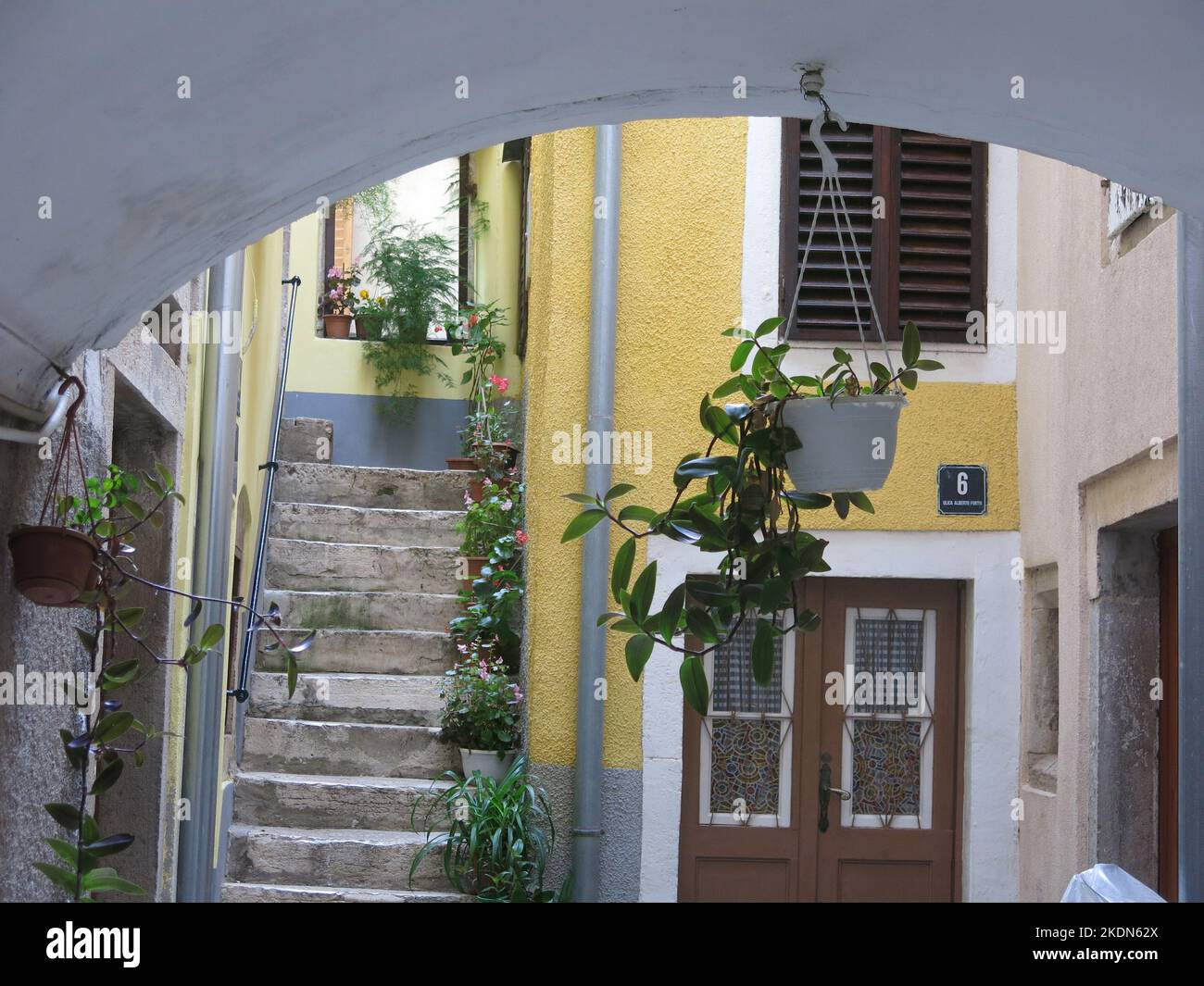 In the medieval streets of the old town of Cres, stone staircases lead ...
