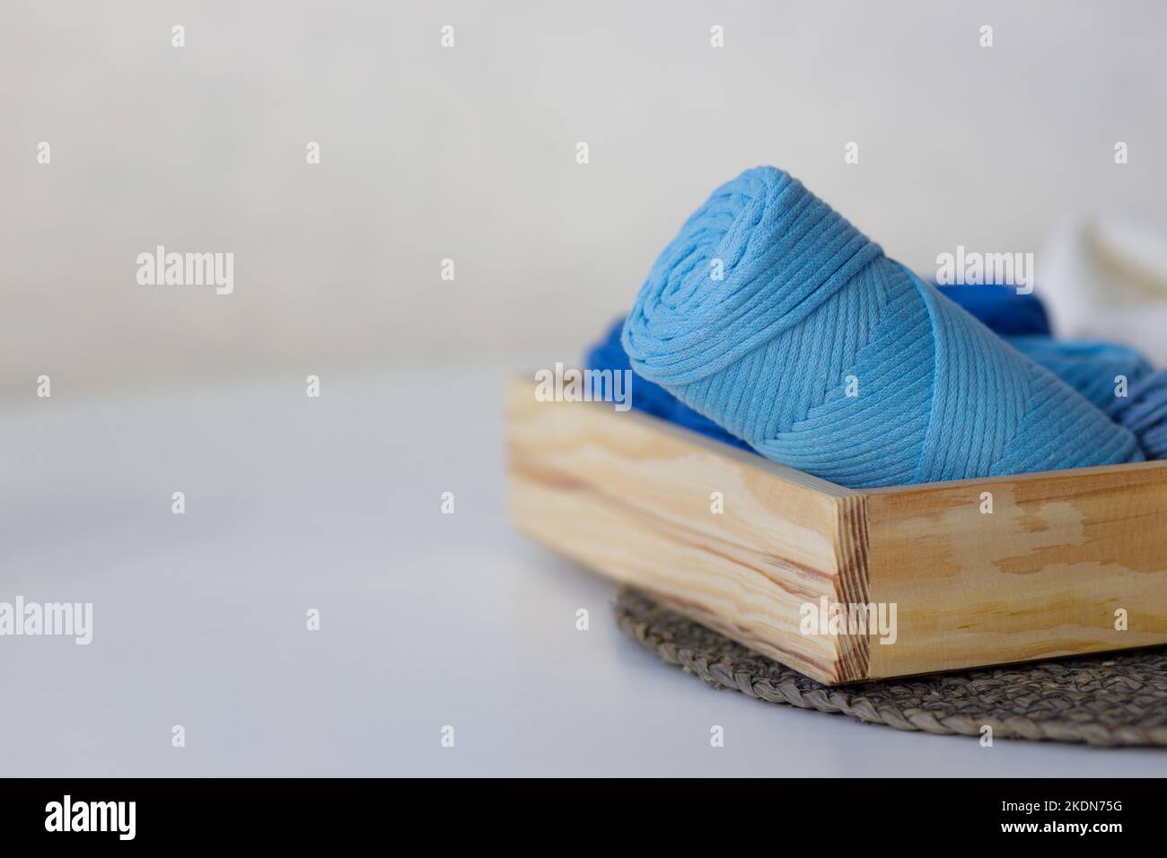 Part of a wooden box with balls of ropes in blue and cyan colors on a ...