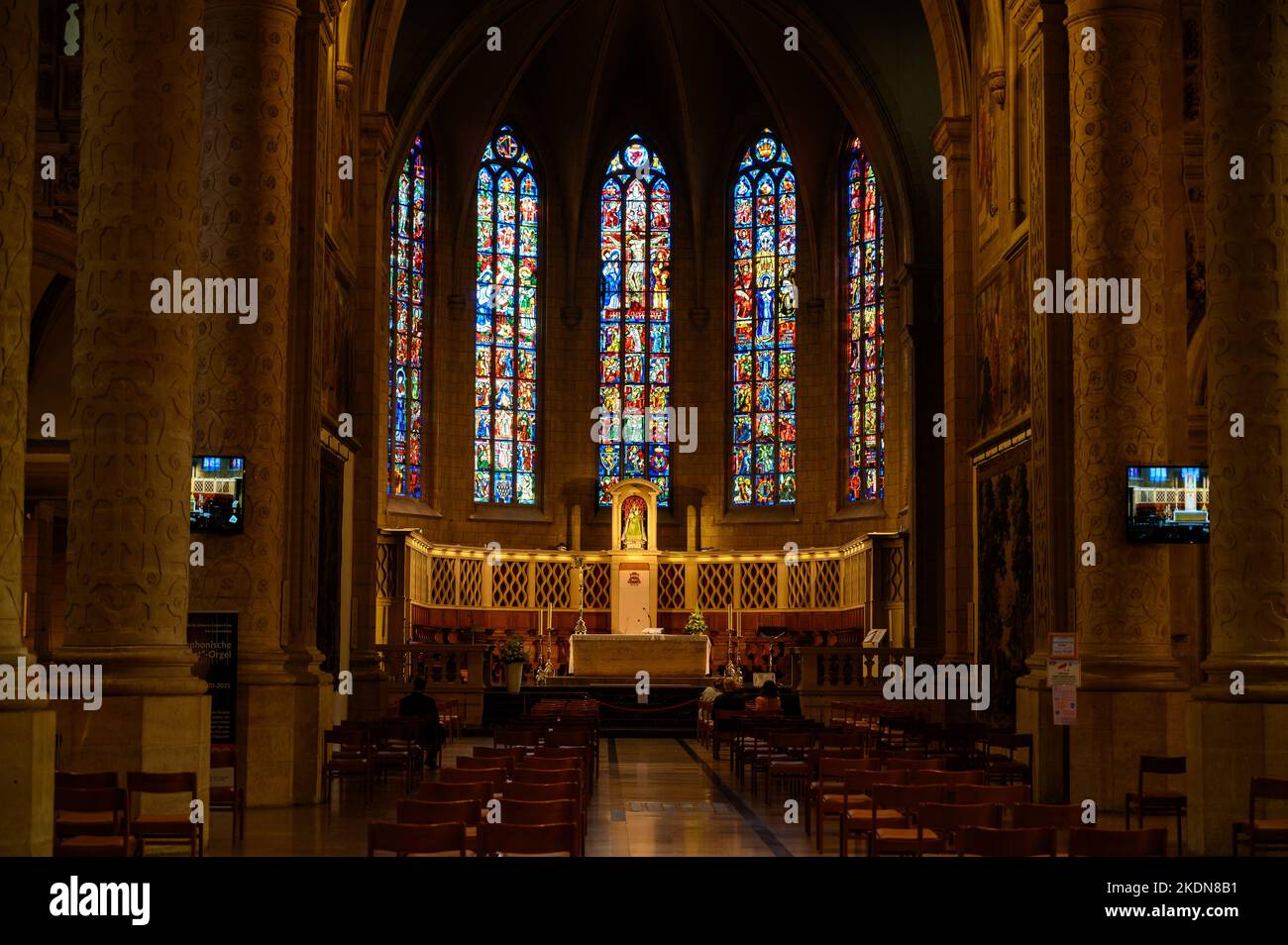 The central altar and stained-glass windows above it in the Notre-Dame ...