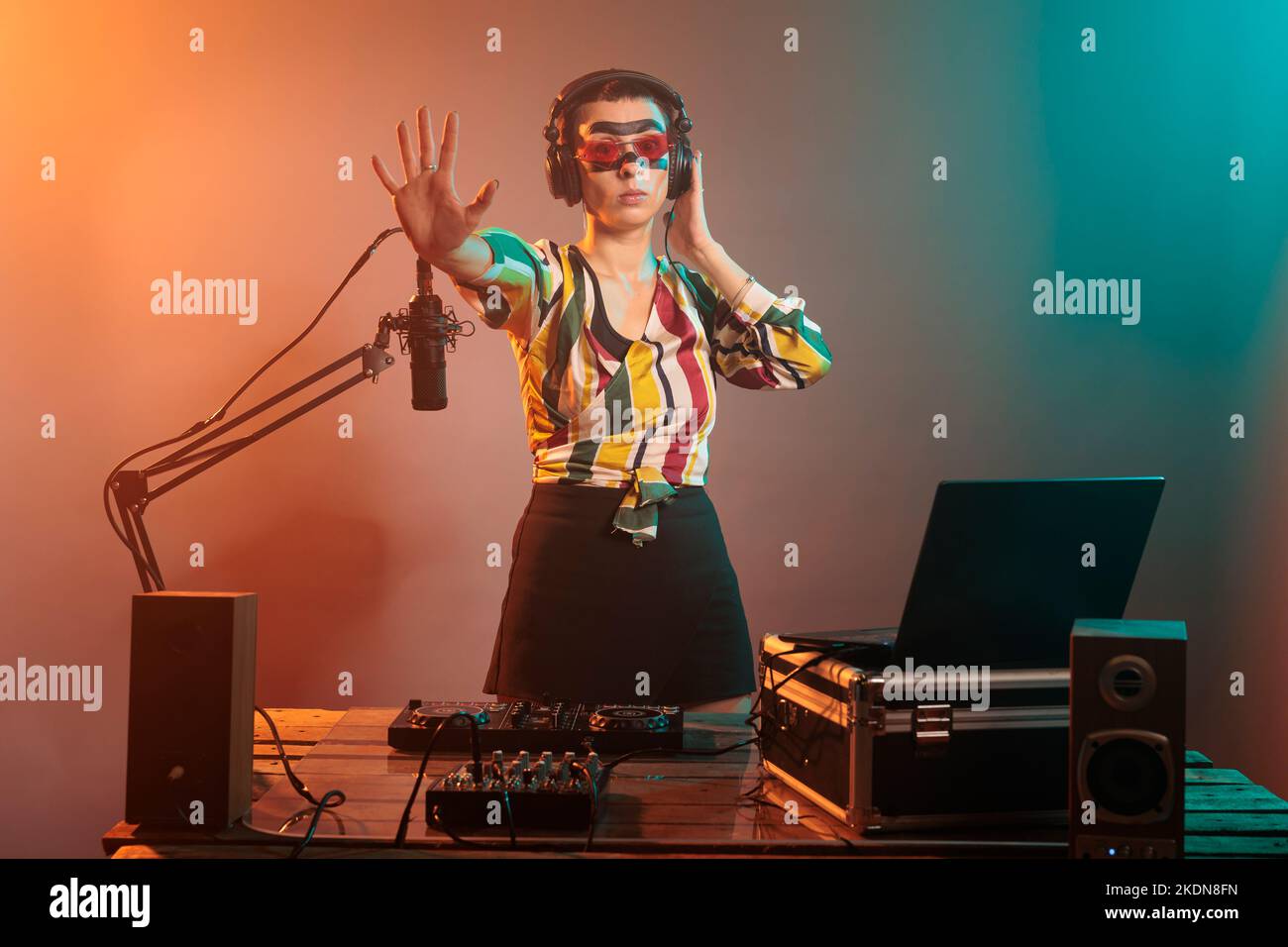 Modern musician doing stop sign with palm and listening to sounds in ...