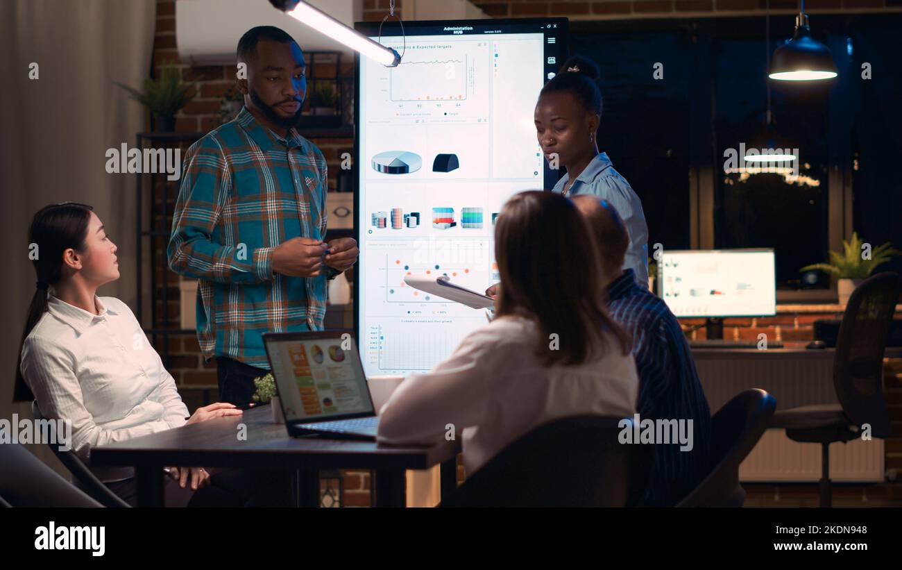 African american coworkers presenting company research statistics ...