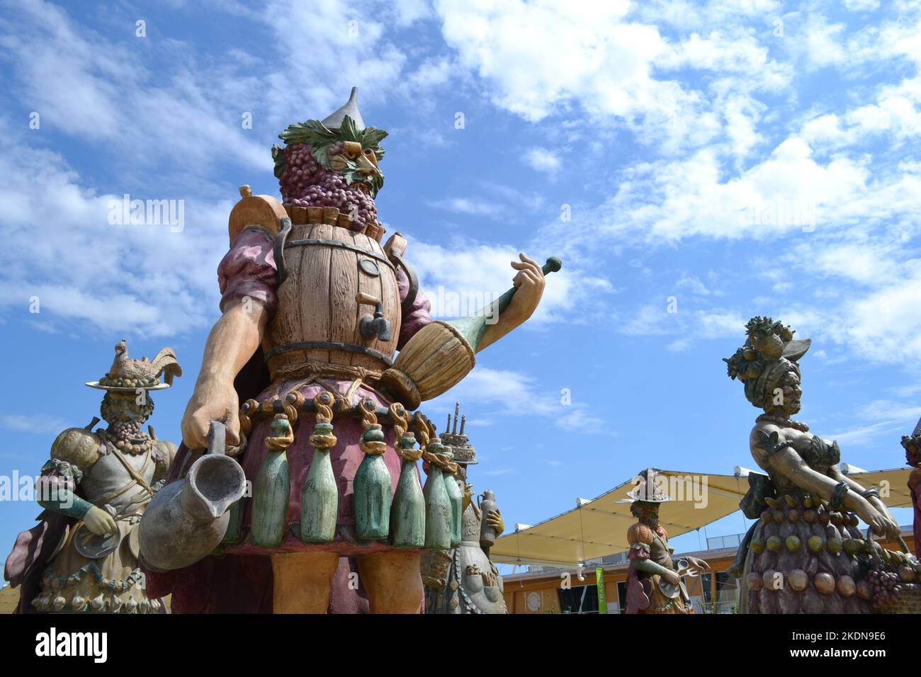 Statue of Enolo winemaker standing in a group of statues of The Food ...