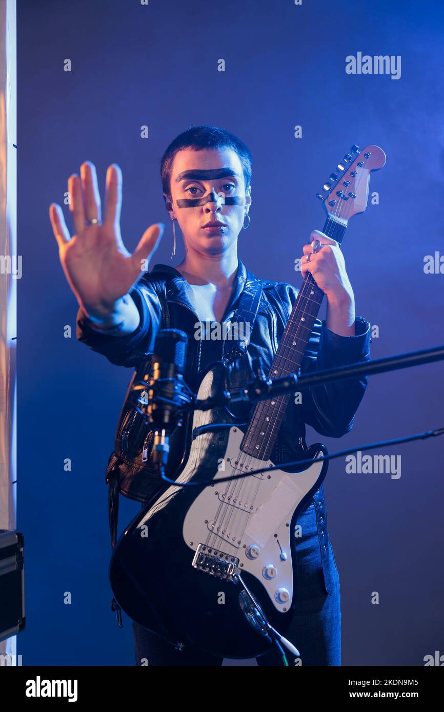 Musical artist showing stop sign with palm, doing serious break symbol ...