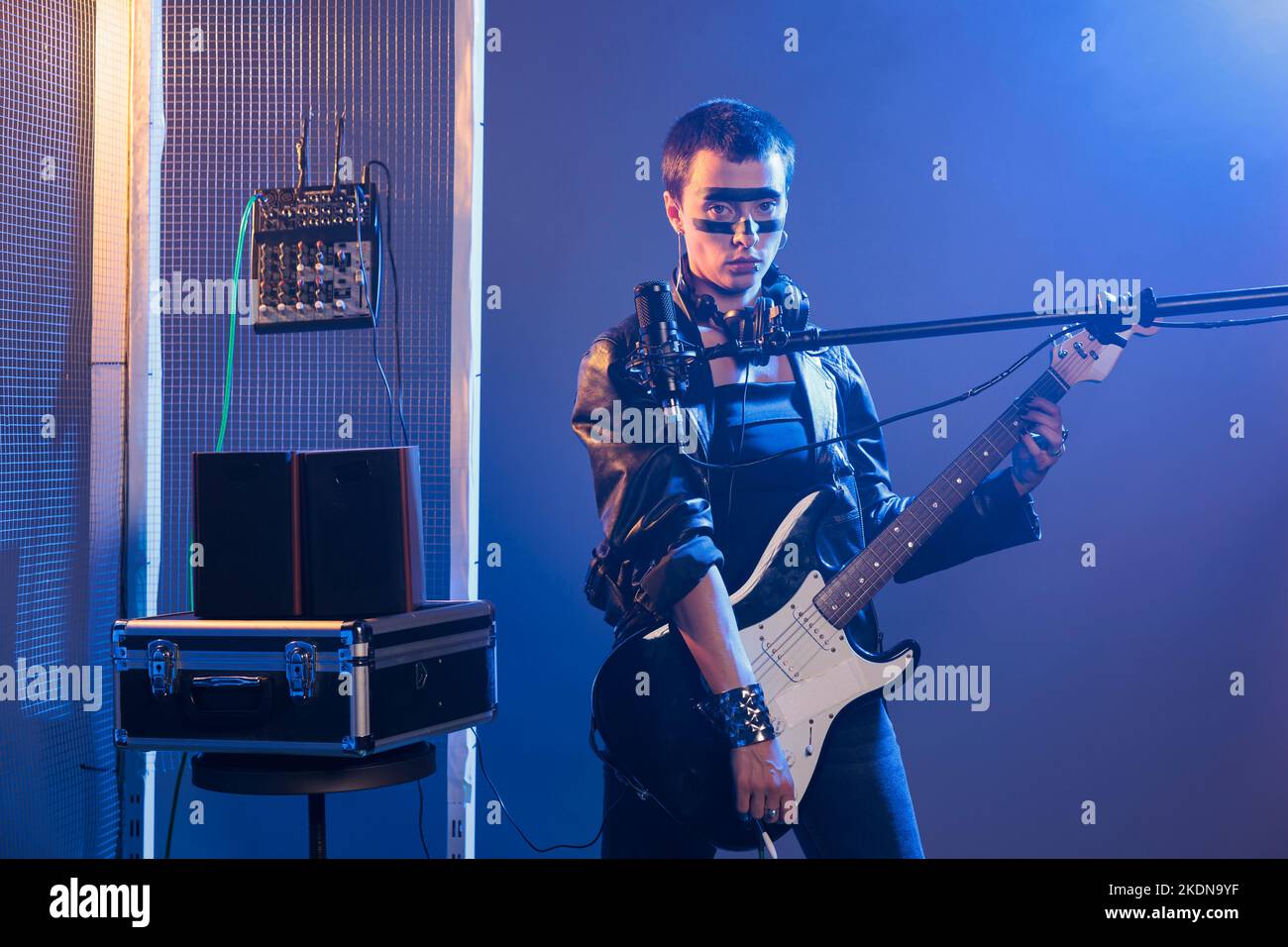 Alternative singer playing guitar and rock song, singing heavy metal ...