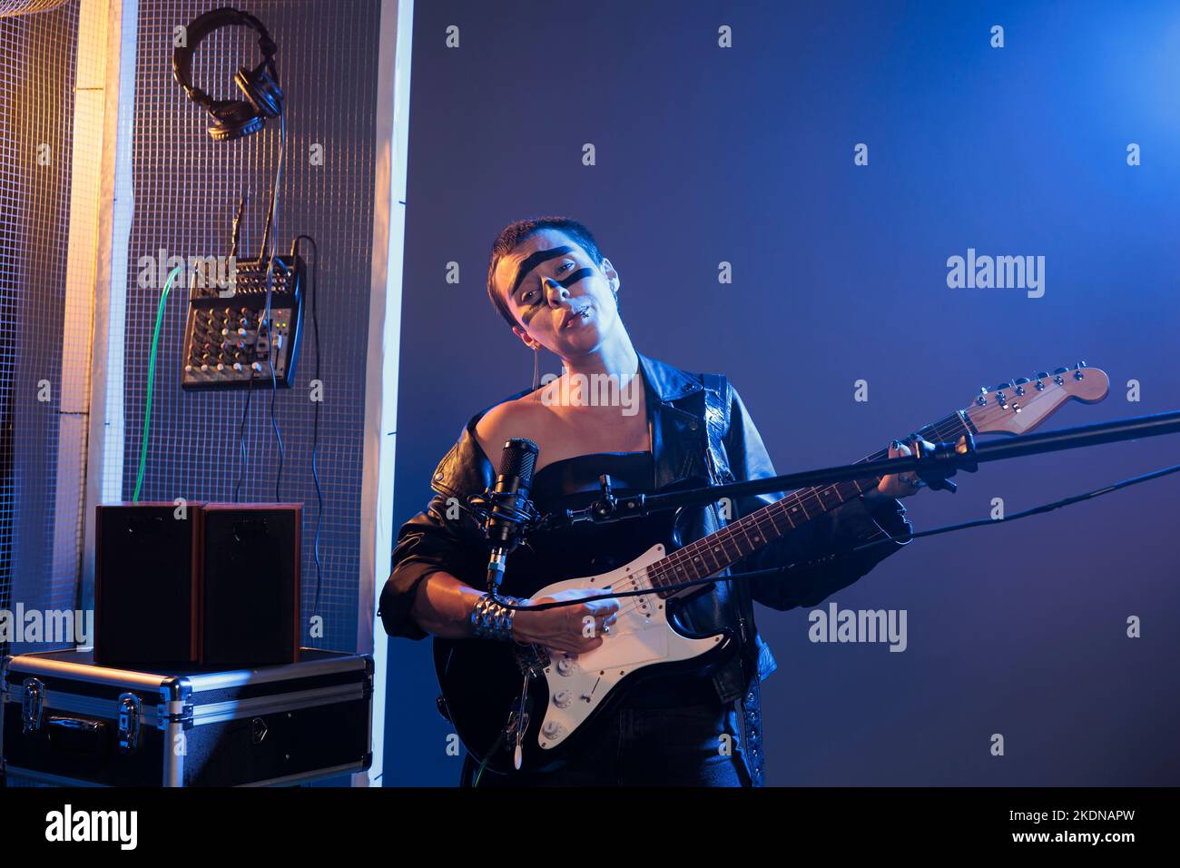 Crazy guitarist doing live show singing heavy metal music with guitar ...