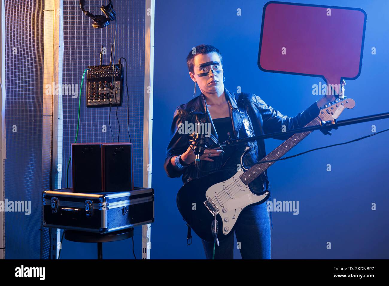 Female rock performer showing speech bubble cartboard sign to advertise ...