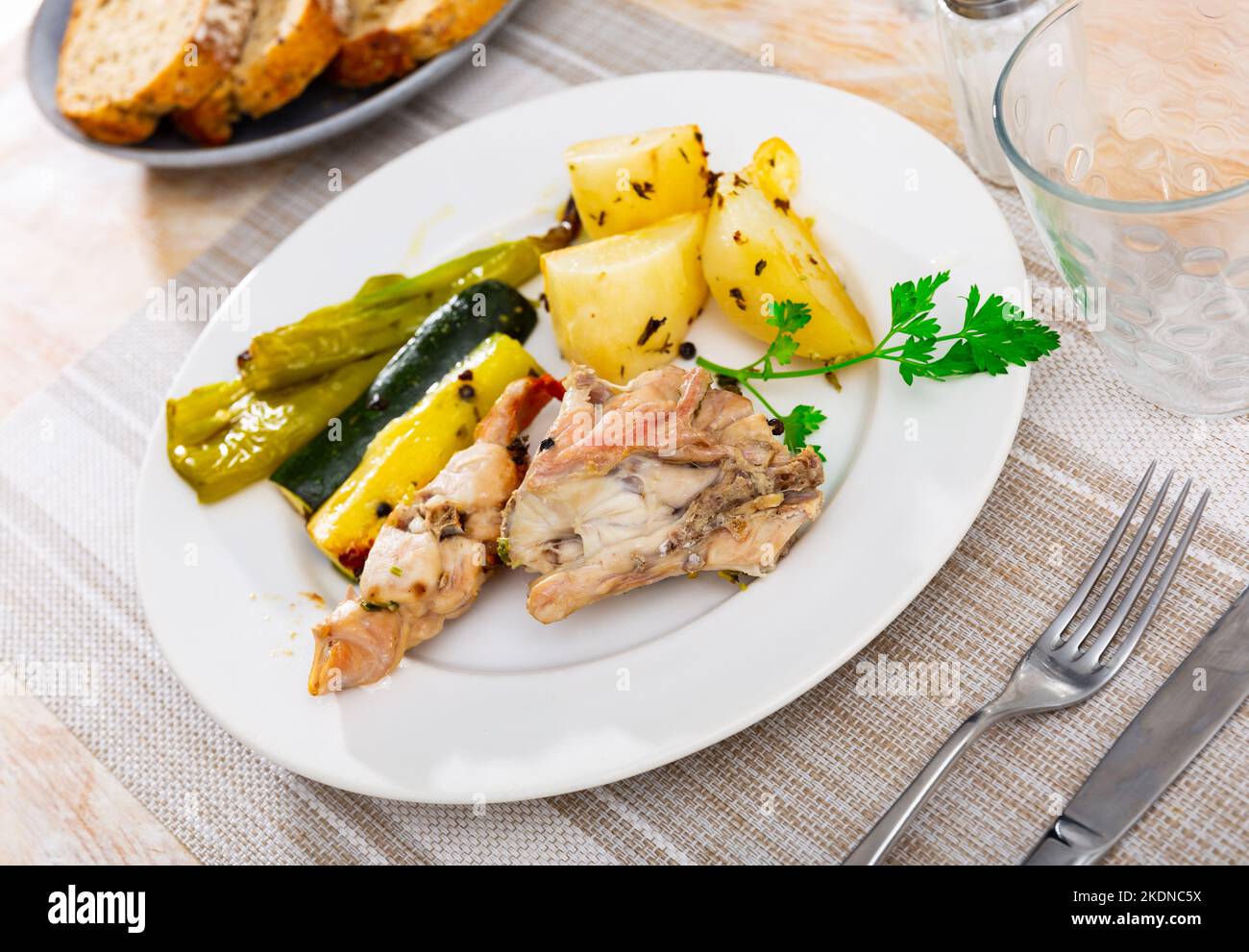 Roasted rabbit served with vegetable garnish Stock Photo - Alamy