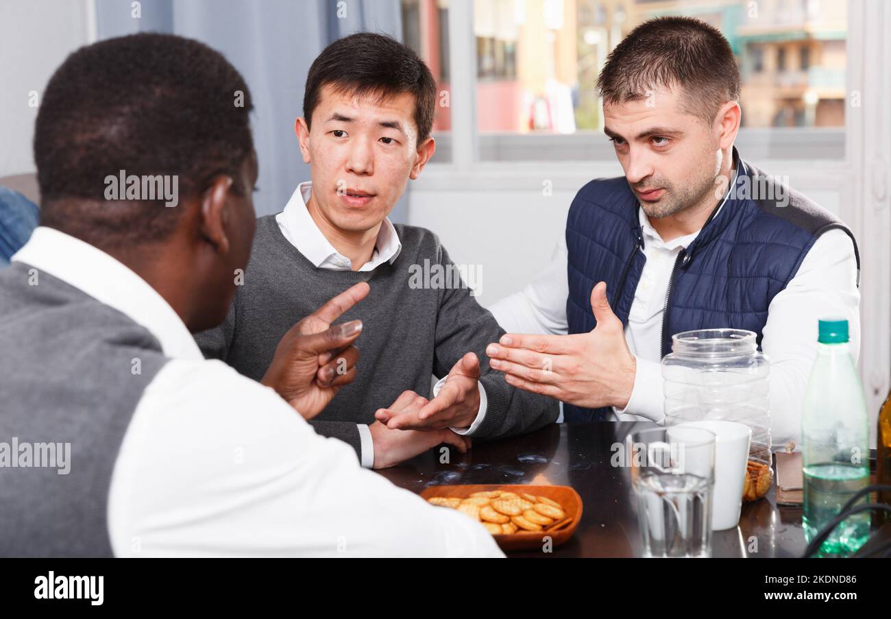 Group of friends discussing serious hi-res stock photography and images ...