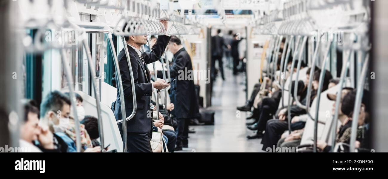 Passengers traveling by Tokyo metro. Business people commuting to work ...