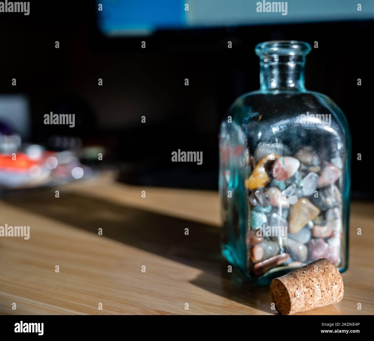 Glass bottle half full of rounded pebbles and rocks Stock Photo - Alamy