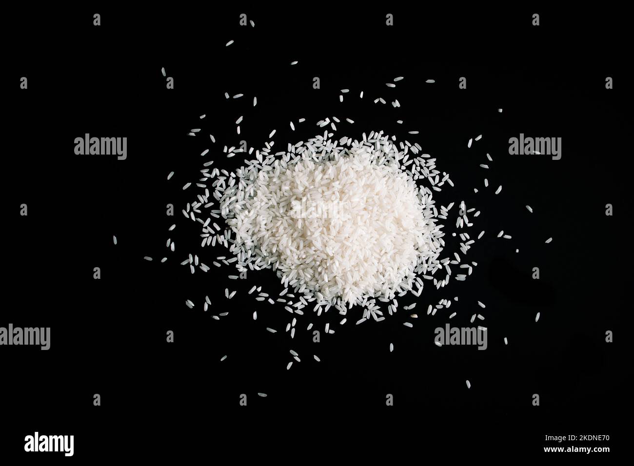 Pile of uncooked white rice on black background. Natural organic vegan ...