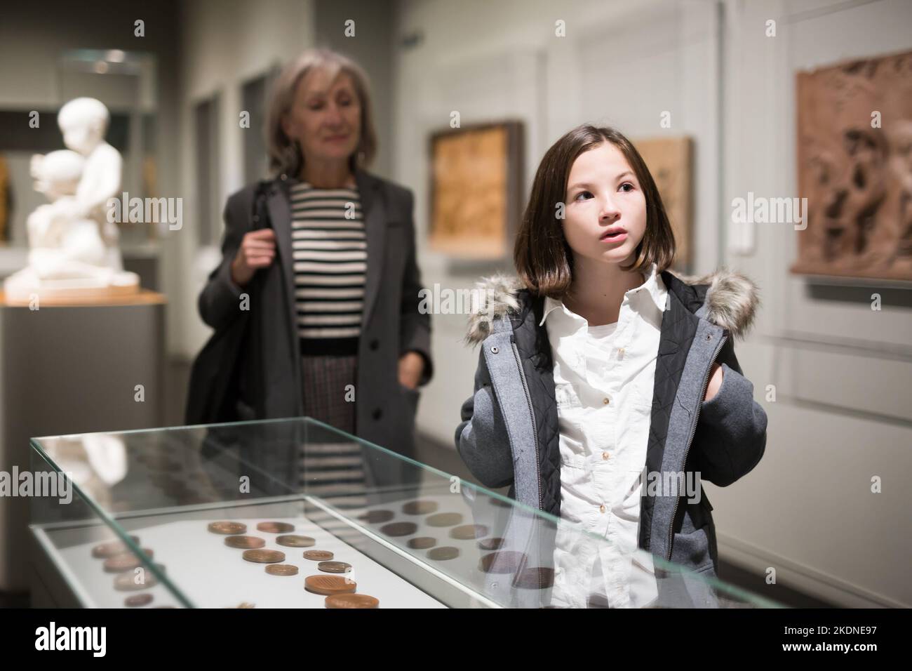 Interested preteen girl exploring artworks in museum of applied arts ...