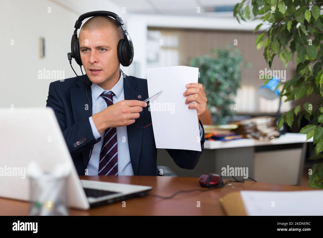 Call center man operator with headset talking with client in office ...