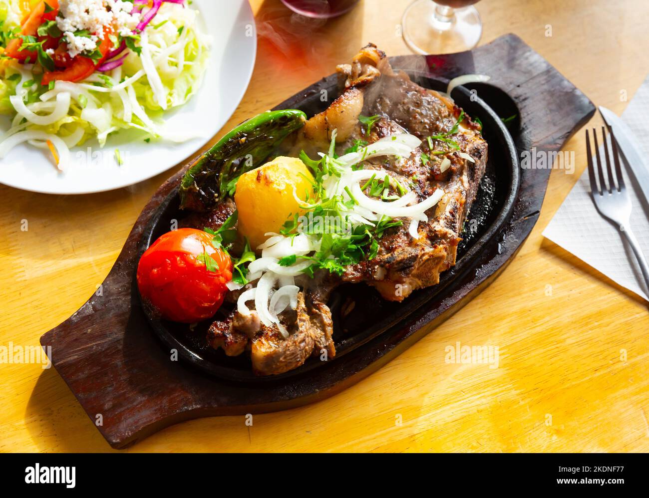 Grilled beef chop dinner served with vegetable garnish Stock Photo - Alamy