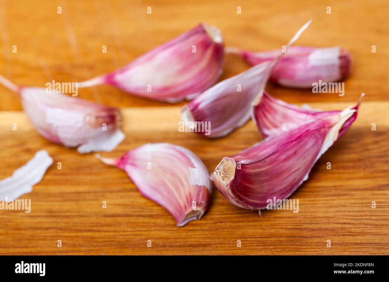 Cutting board with fresh seasonings on a wooden background. White ...