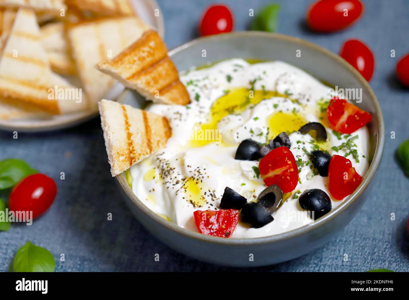 Greek yogurt dip with olives and croutons Stock Photo - Alamy