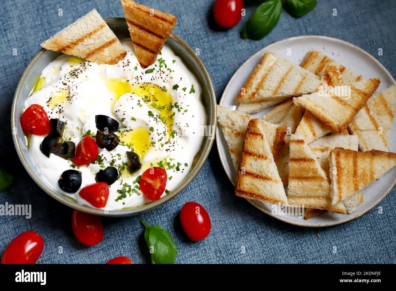 Greek yogurt dip with olives and croutons Stock Photo - Alamy