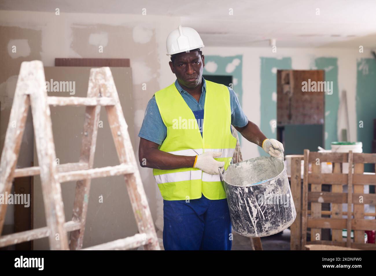 Portrait of an african american builder, working in the process of ...