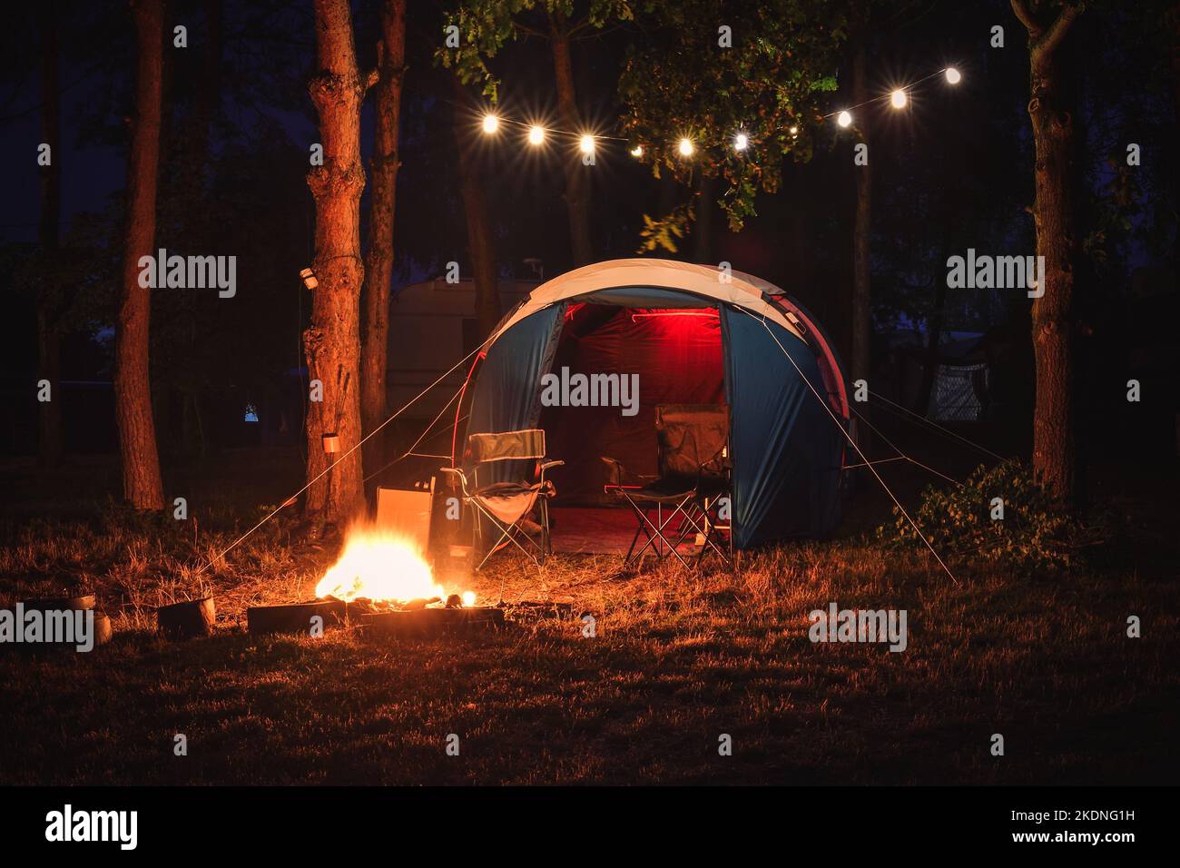 Atmospheric night adventure. Tent with a midnight fire in the forest ...