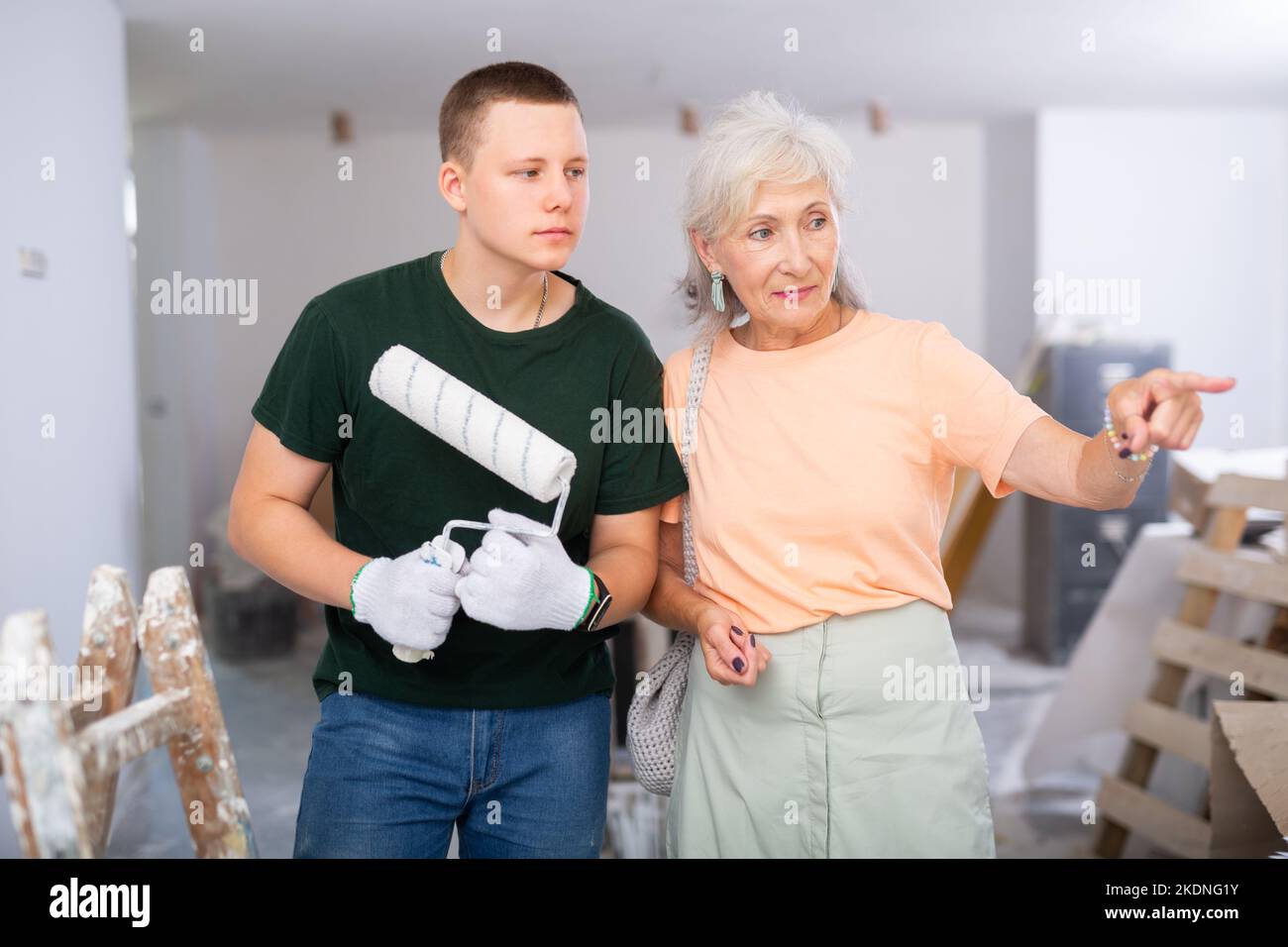 Guy helps his grandmother to renovate the room during holidays. Grandma ...