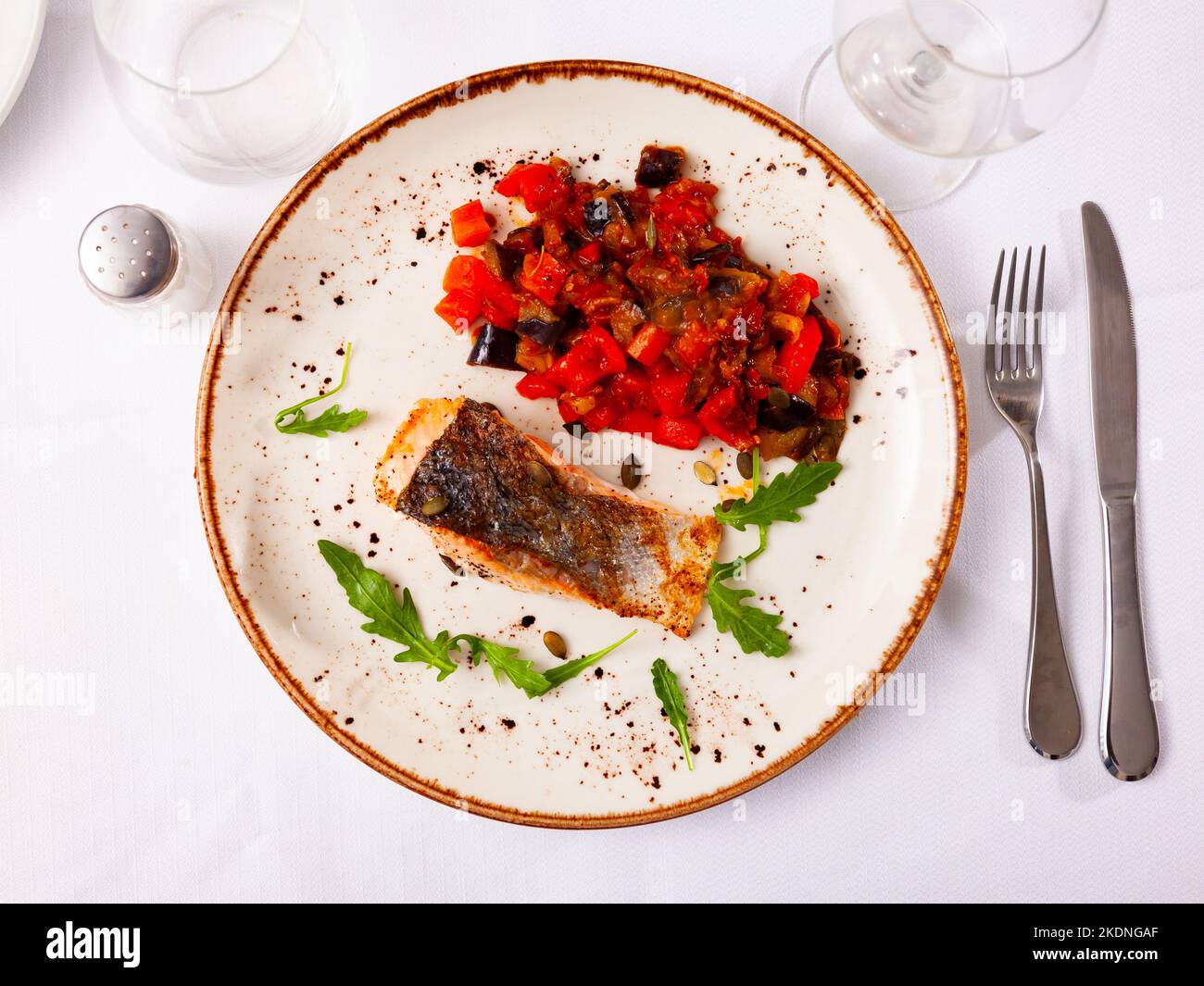 Salmon steak stewed vegetables served on table Stock Photo - Alamy