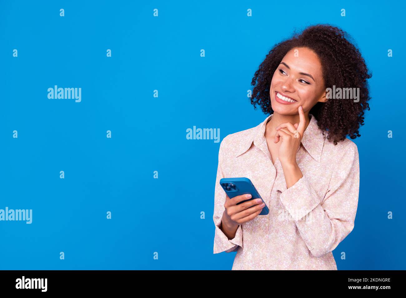 Photo portrait of cute young girl curly hair hold device minded look ...