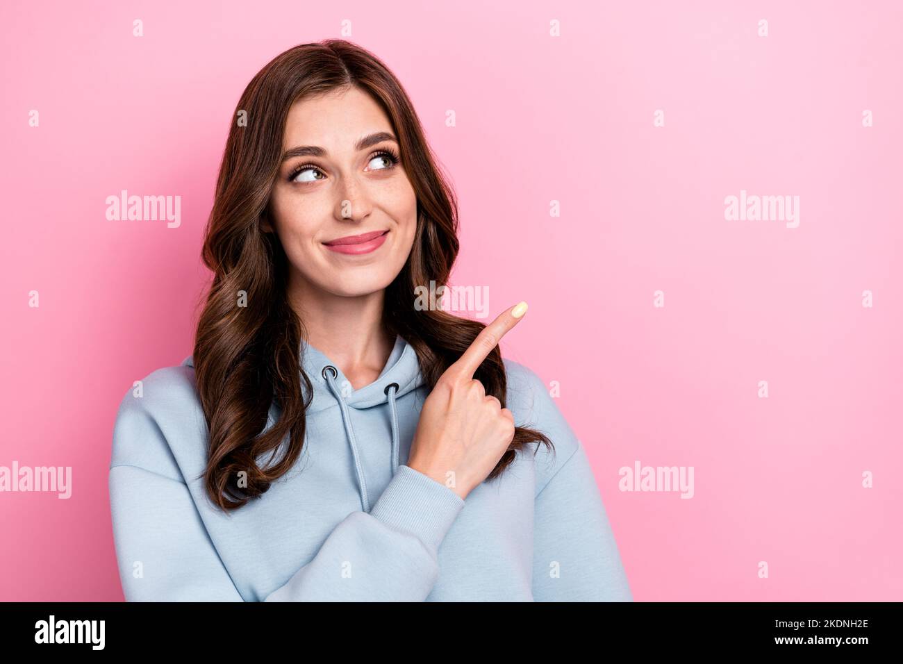 Photo of gorgeous positive lady look indicate finger empty space ad ...