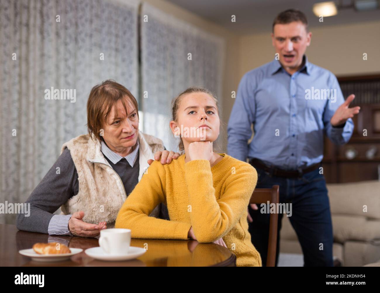 Portrait of upset girl scolded by parents at home Stock Photo - Alamy