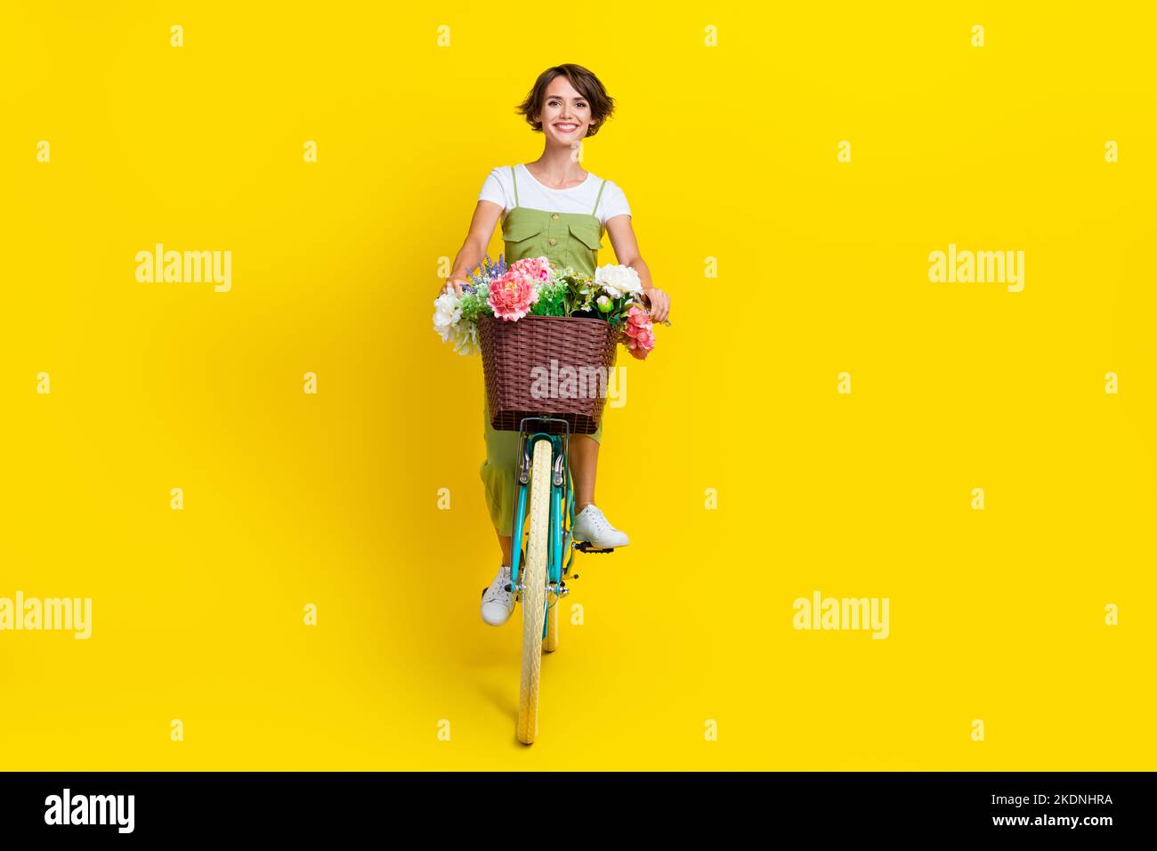 Full body photo of lovely young woman ride bicycle cheerful flower ...