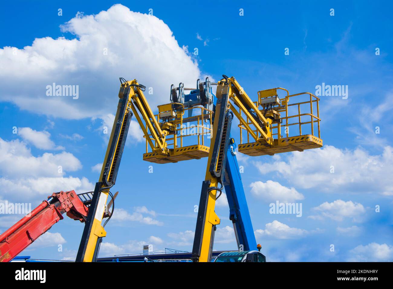 Lift buckets boom in the blue sky with clouds Stock Photo - Alamy