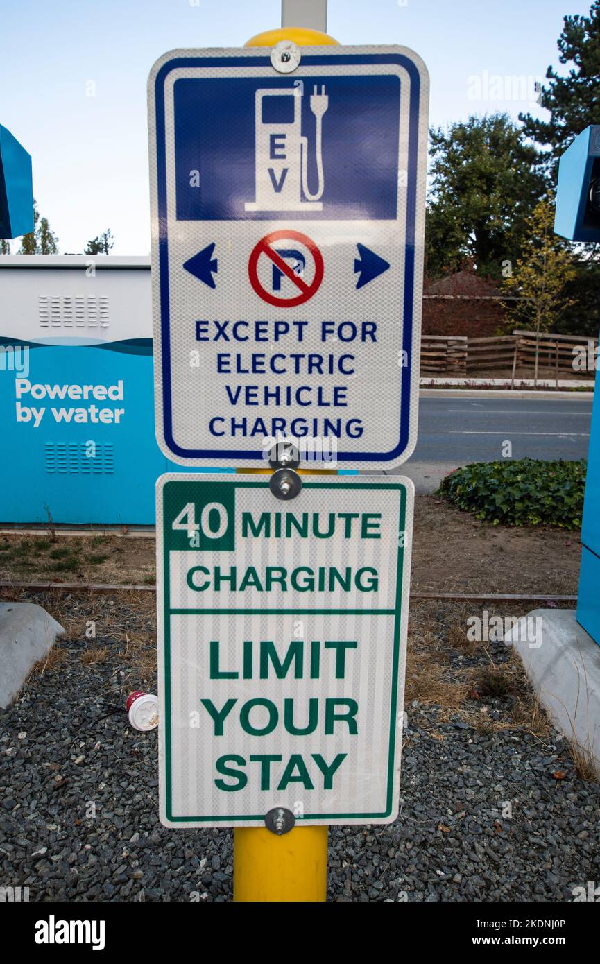 Limit Your Stay sign at vehicle charging station at Saanich Plaza Stock ...