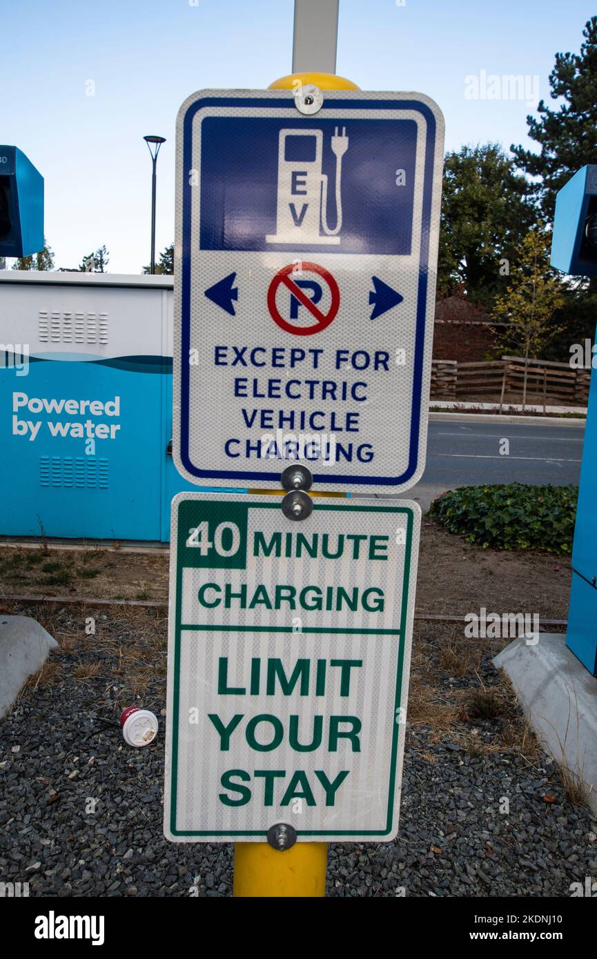 Limit Your Stay sign at vehicle charging station at Saanich Plaza Stock ...