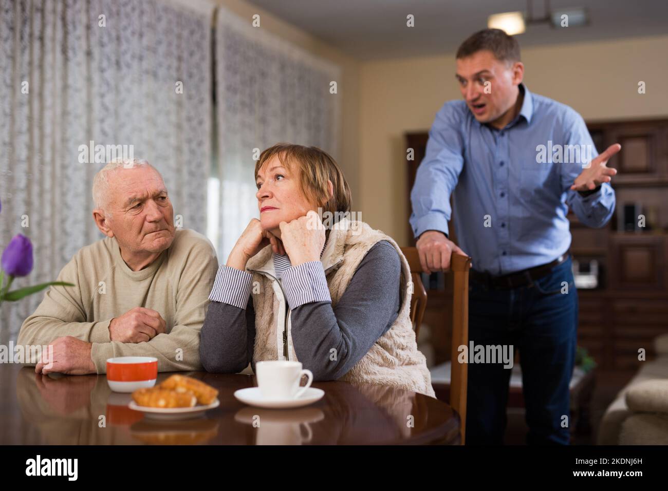 Man scolding elderly parents Stock Photo - Alamy