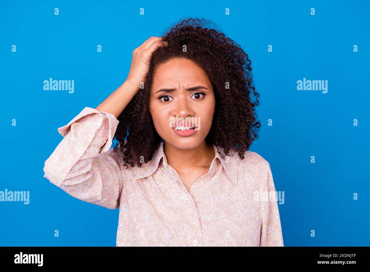 Close up photo of cute young woman curly hair touch head confused make ...