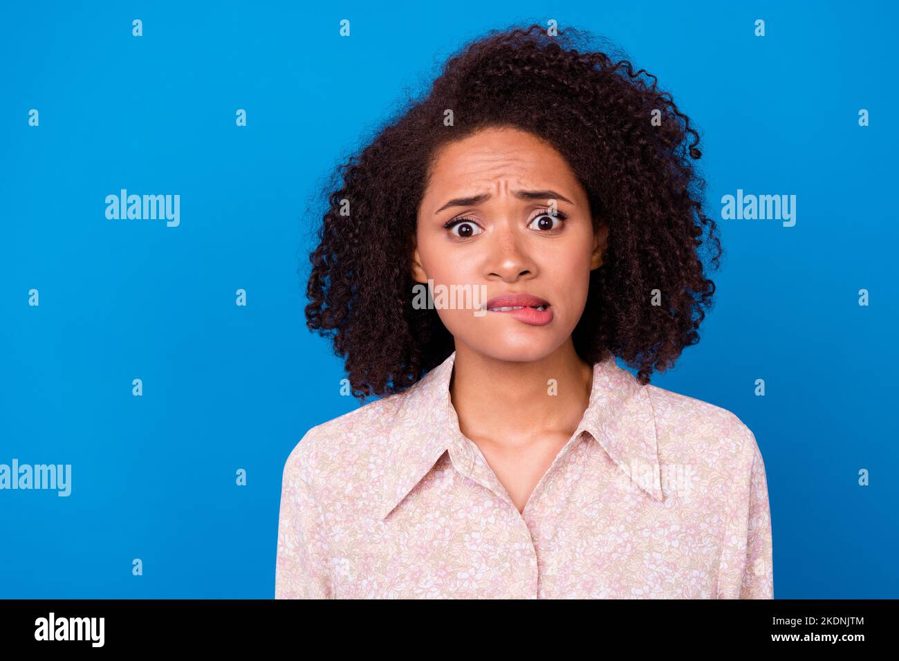 Portrait of worried puzzled lady bite lips stare scared look camera ...
