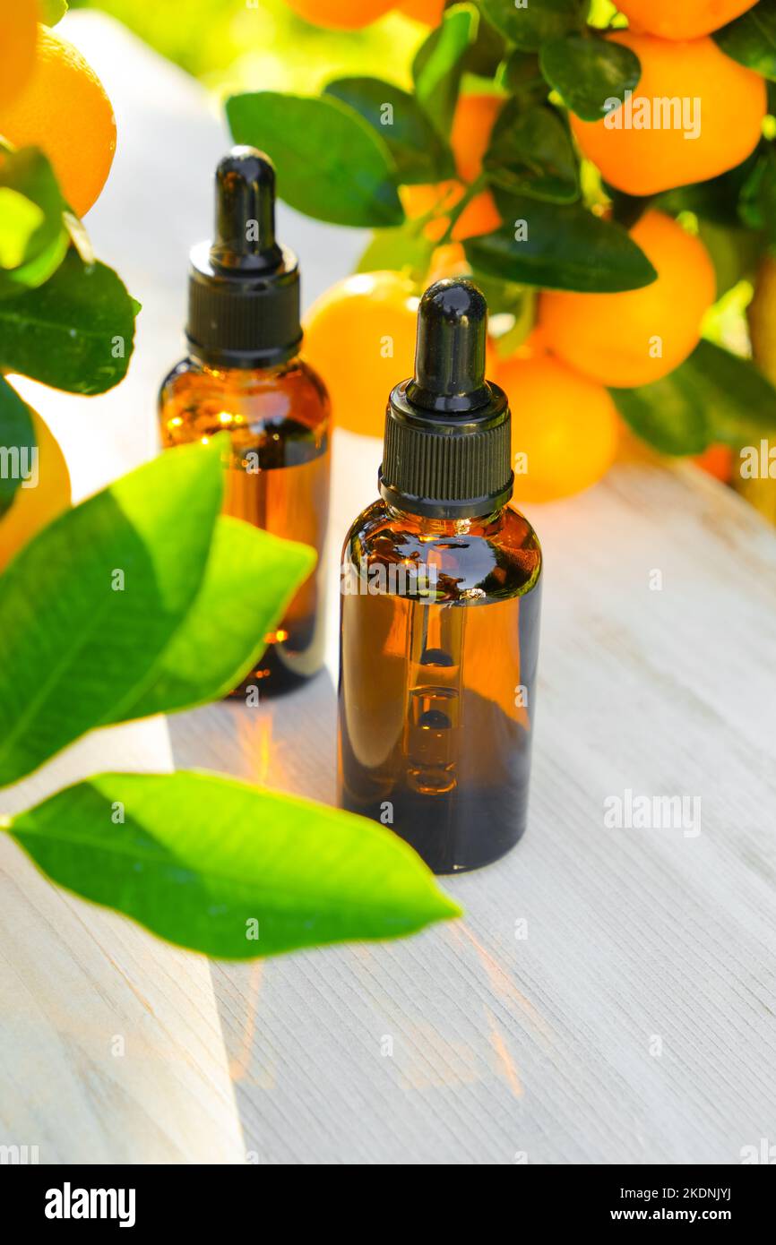 essential natural citrus oils. glass brown bottles and tangerine ...