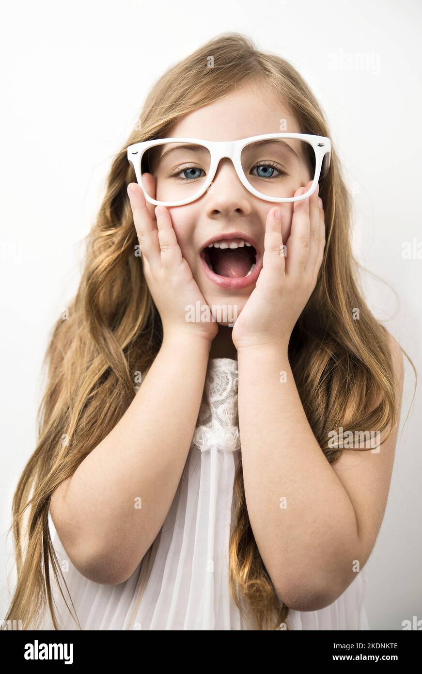 Surprised face of beautiful cute little girl with glasses Stock Photo ...